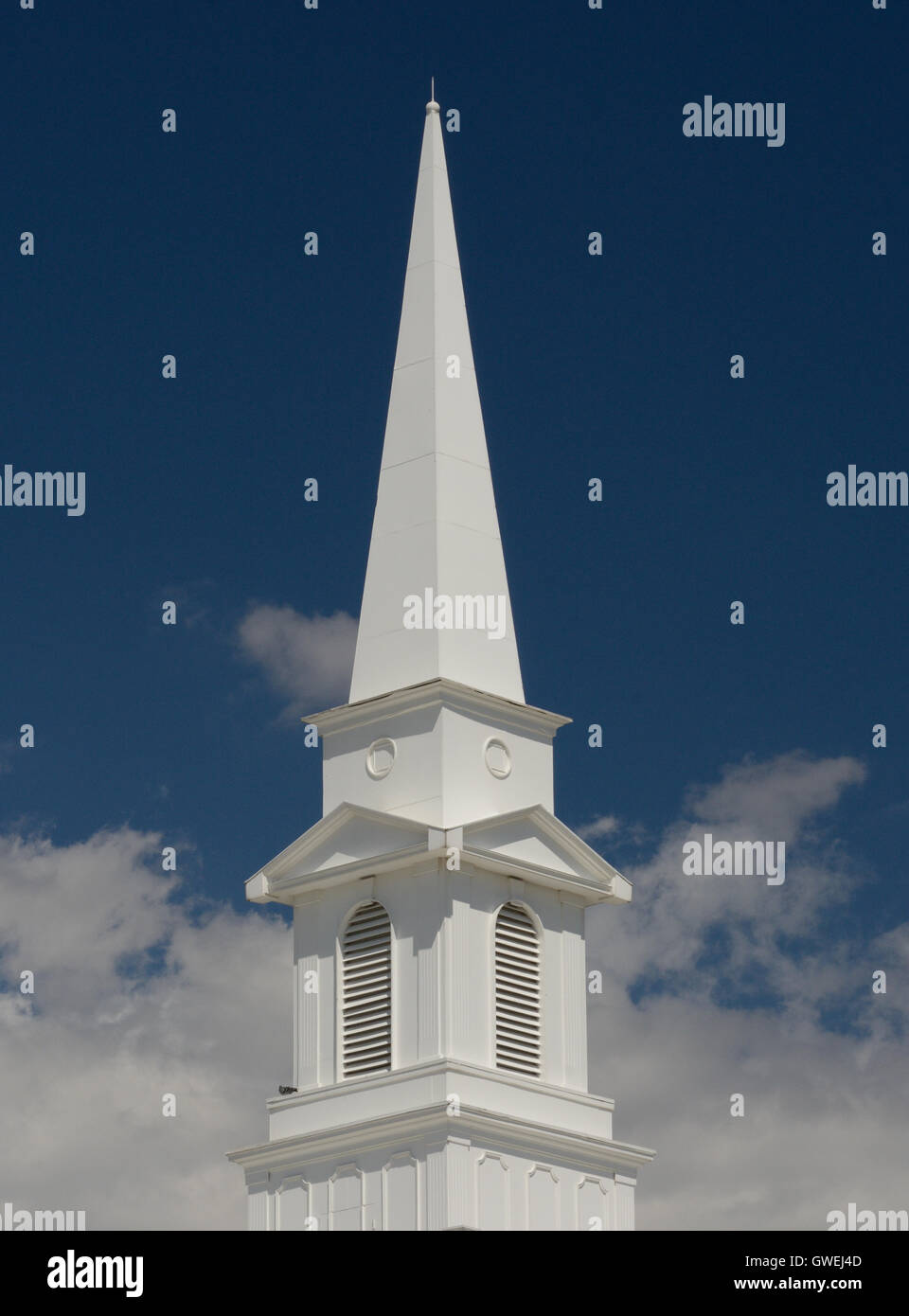 Steeple with cross against clouds and dark blue sky Stock Photo - Alamy