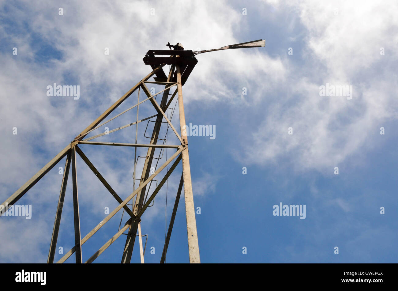 Metal wind vane structure, perspective from below, under a blue sky ...