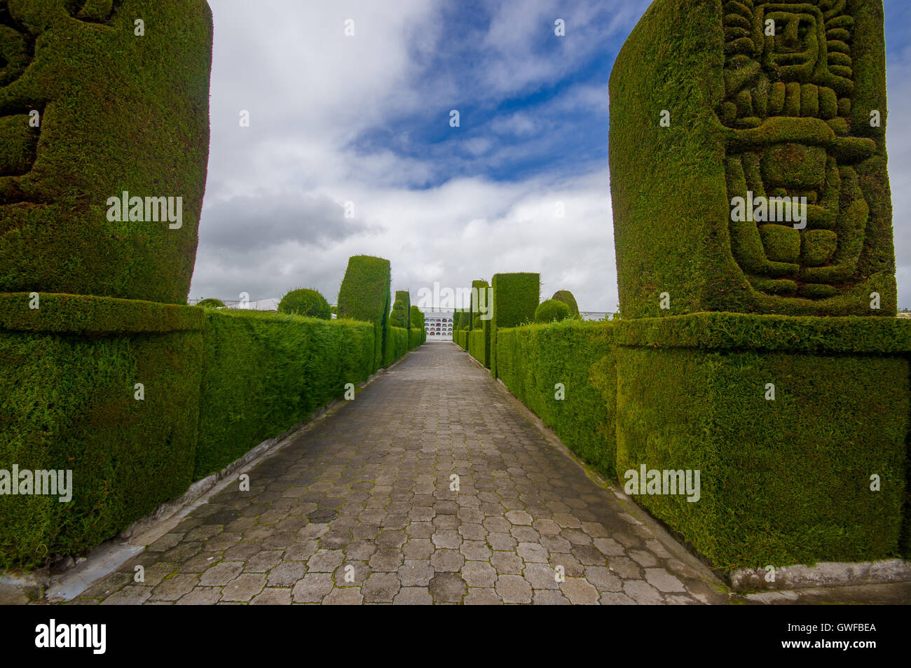 TULCAN, ECUADOR - JULY 3, 2016: cemetery path with plants sculptures on ...