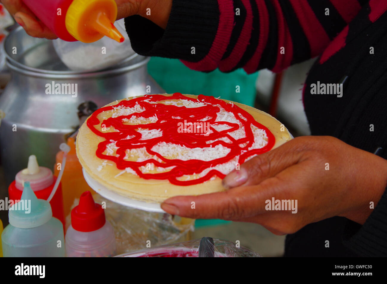 PASTO, COLOMBIA - JULY 3, 2016: woman preparing a dessert with some ...