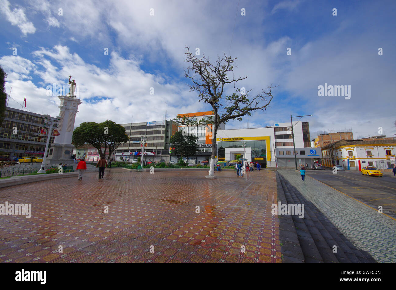 TULCAN, ECUADOR - JULY 3, 2015: some pedestrians walking on the central ...