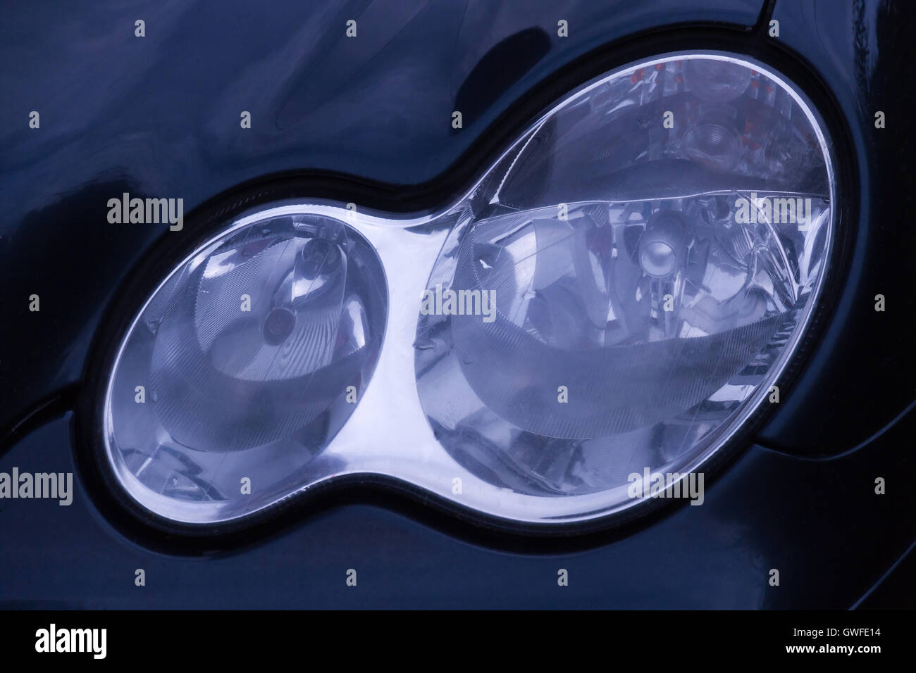 A closeup of the front headlight of a dark black modern car Stock Photo ...