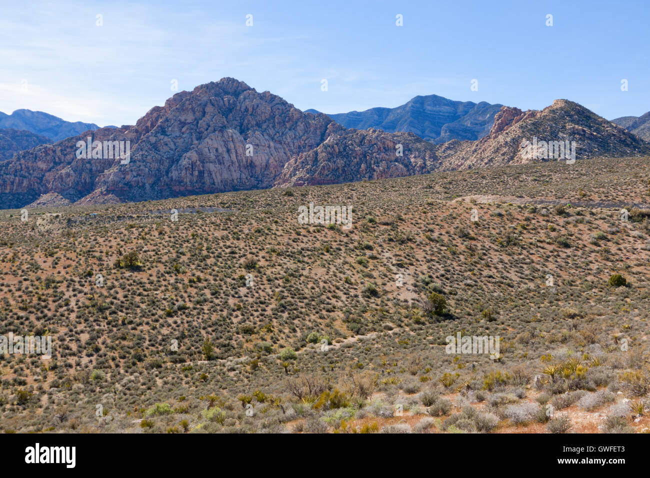 View of dry landscape and red rock formations of the Mojave Desert ...