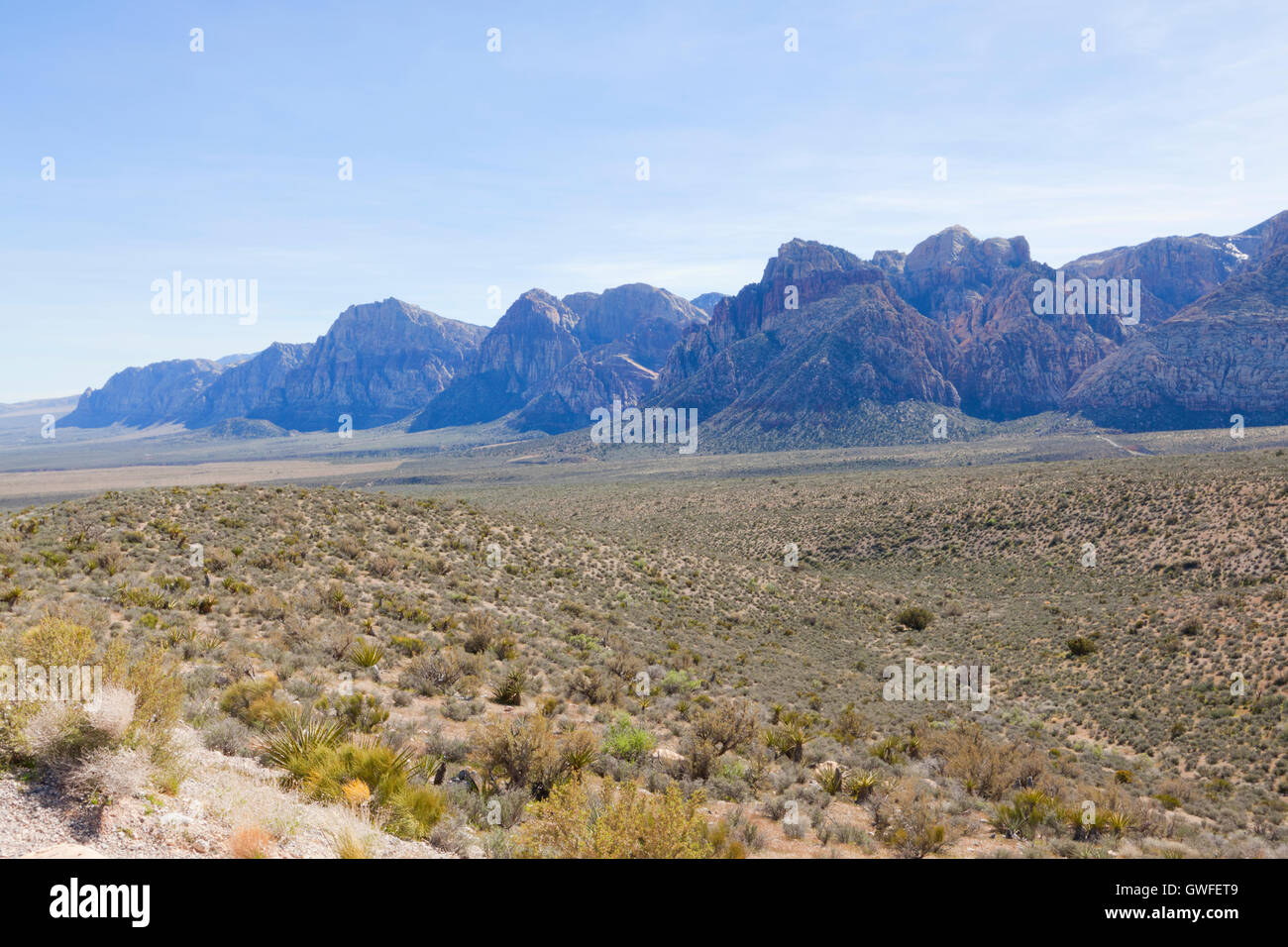 View of dry landscape and red rock formations of the Mojave Desert ...