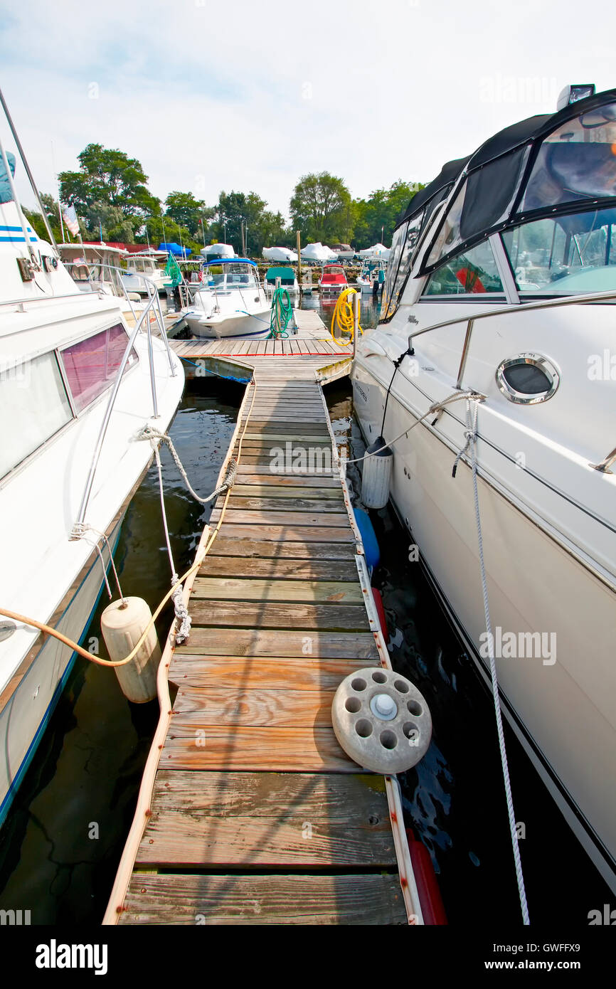 A view of the jetty with private motor yachts, docked in the marina ...