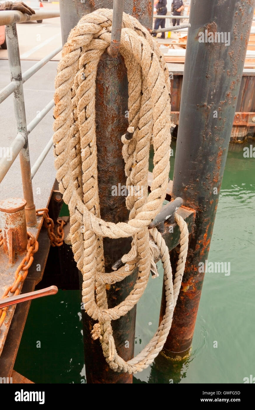 Coiled mooring rope at the marine pier Stock Photo - Alamy