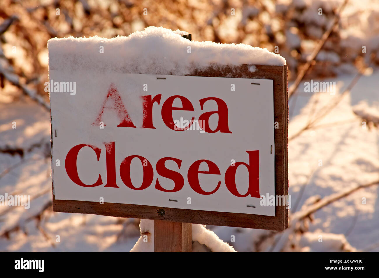 Snow covered sign in the park park at early morning light Stock Photo ...