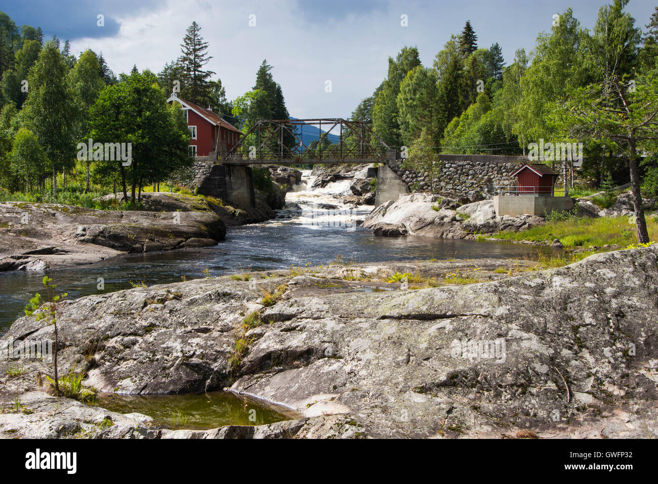Wooden house and a bridge over a brook Stock Photo - Alamy