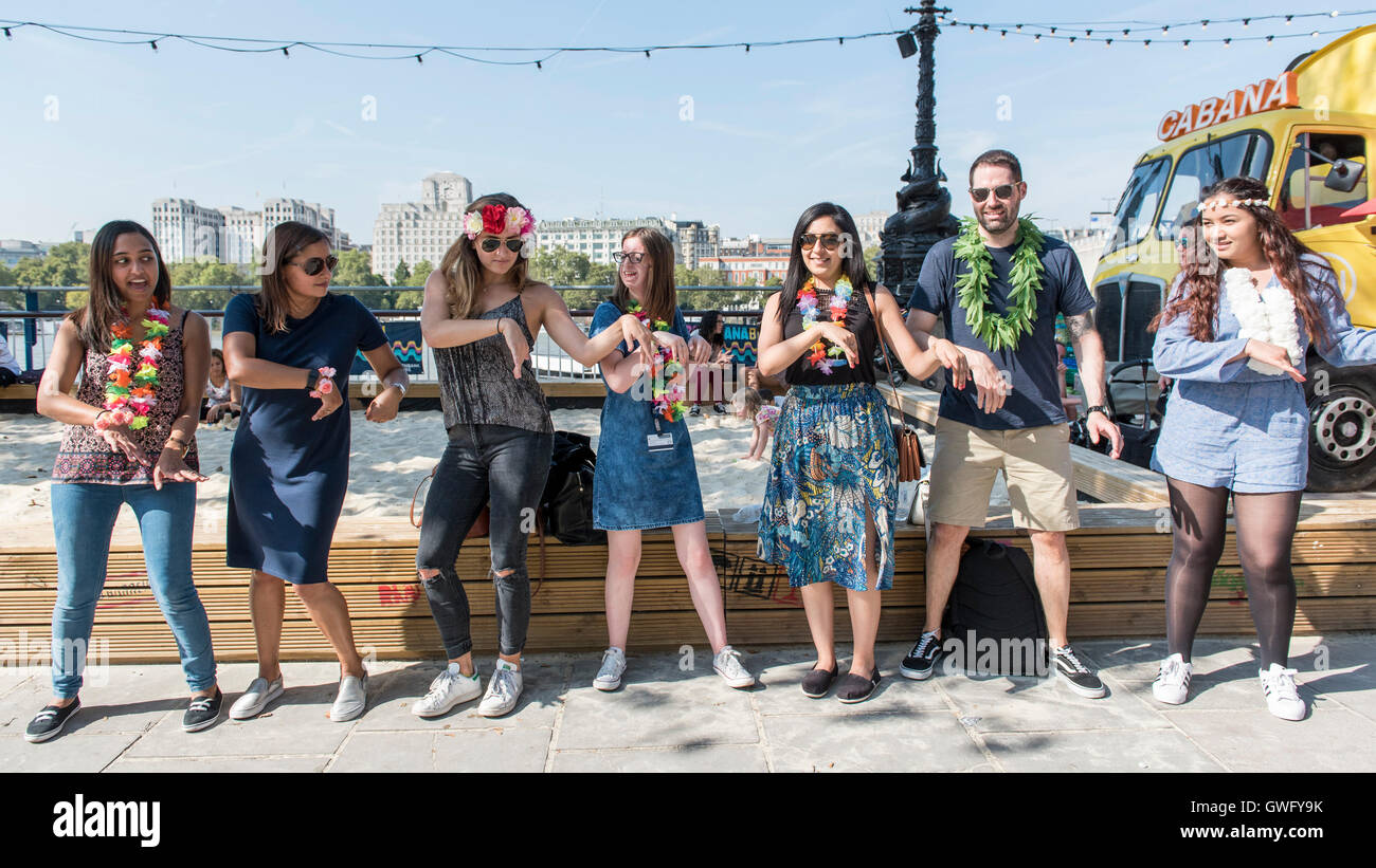 London, UK. 13th Sep, 2016. A group wearing tropical leis perform an ...