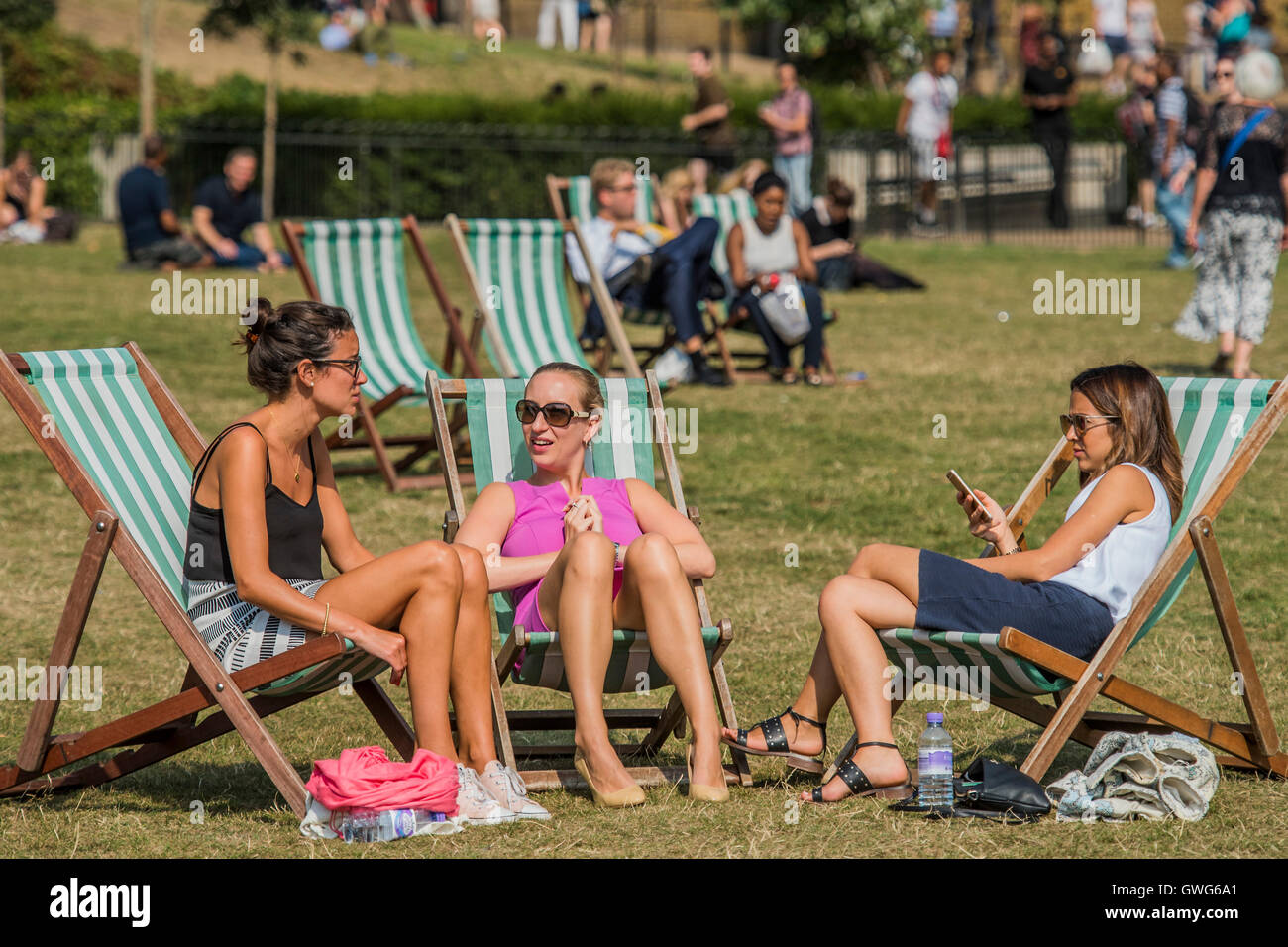 London, UK. 14th September, 2016. Workers and tourists enjoy the deckchairs in the unseasonally ...
