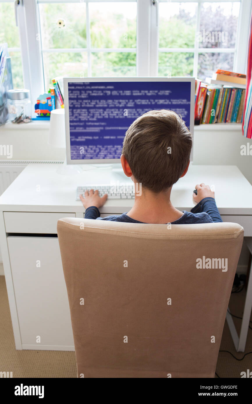 Teenage Boy In Bedroom Writing Computer Code Stock Photo - Alamy