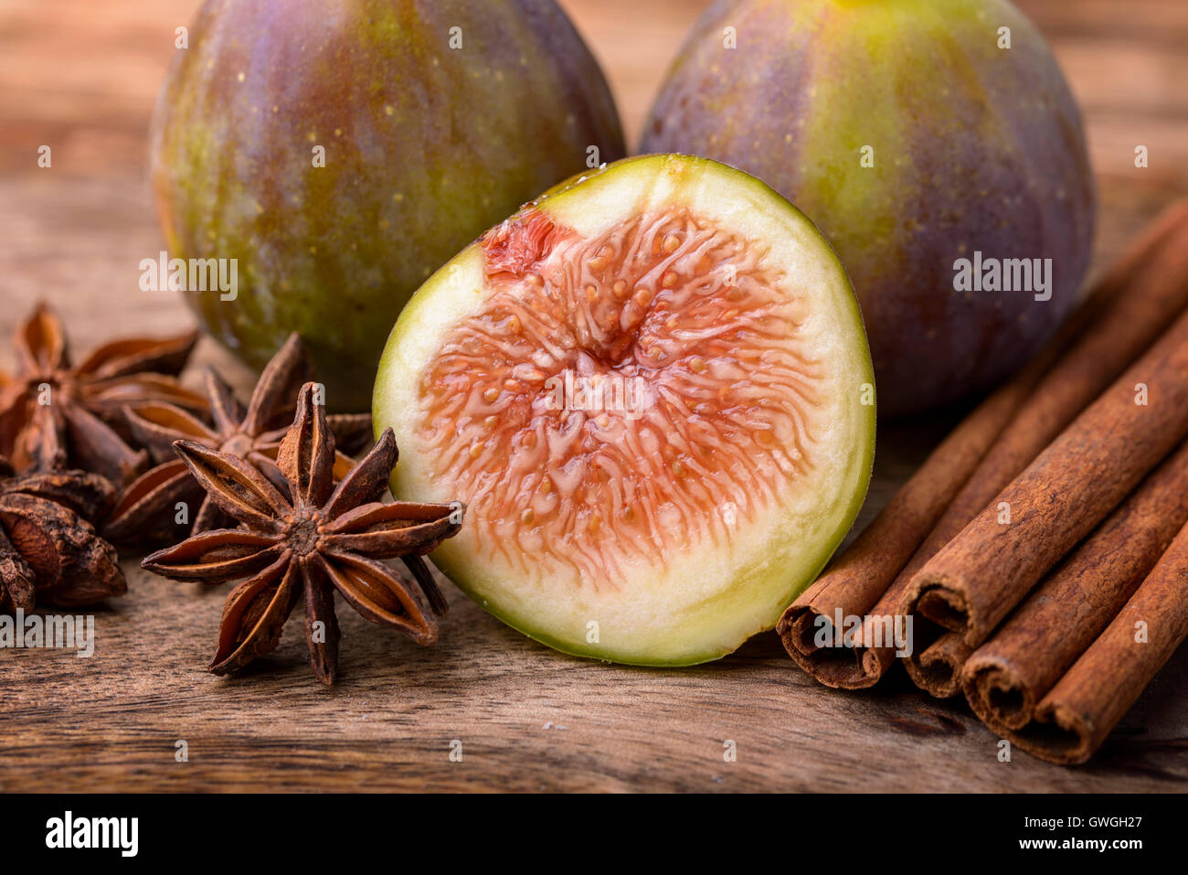 slice of fig with star anise and cinnamon on wood Stock Photo - Alamy