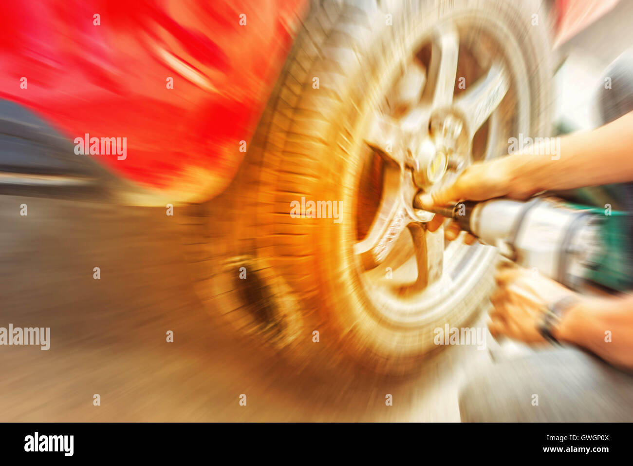 Mechanic the wheel bolts to replace a car garage Stock Photo - Alamy
