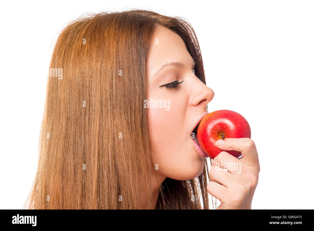 pretty girl bites a ripe red apple on a white background Stock Photo ...
