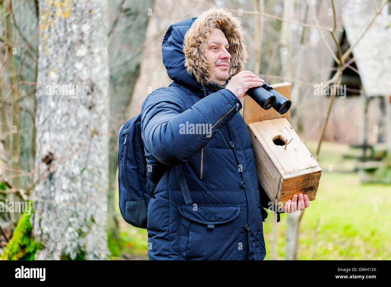 Ornithologist with binoculars and bird cage in the park Stock Photo - Alamy