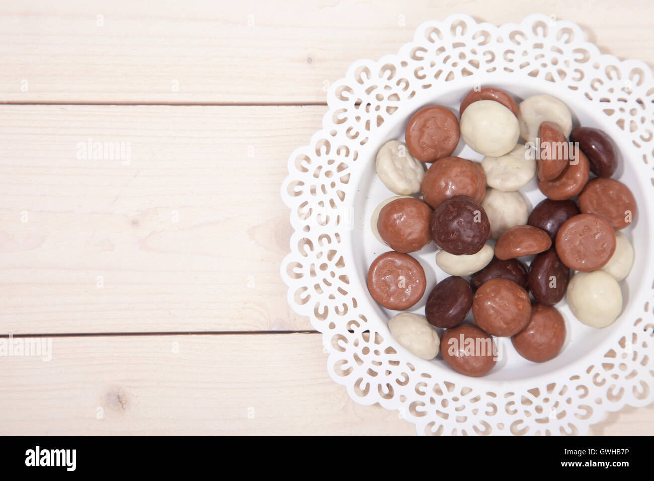 Traditional Dutch chocolate candy pepernoot on white plate on white ...