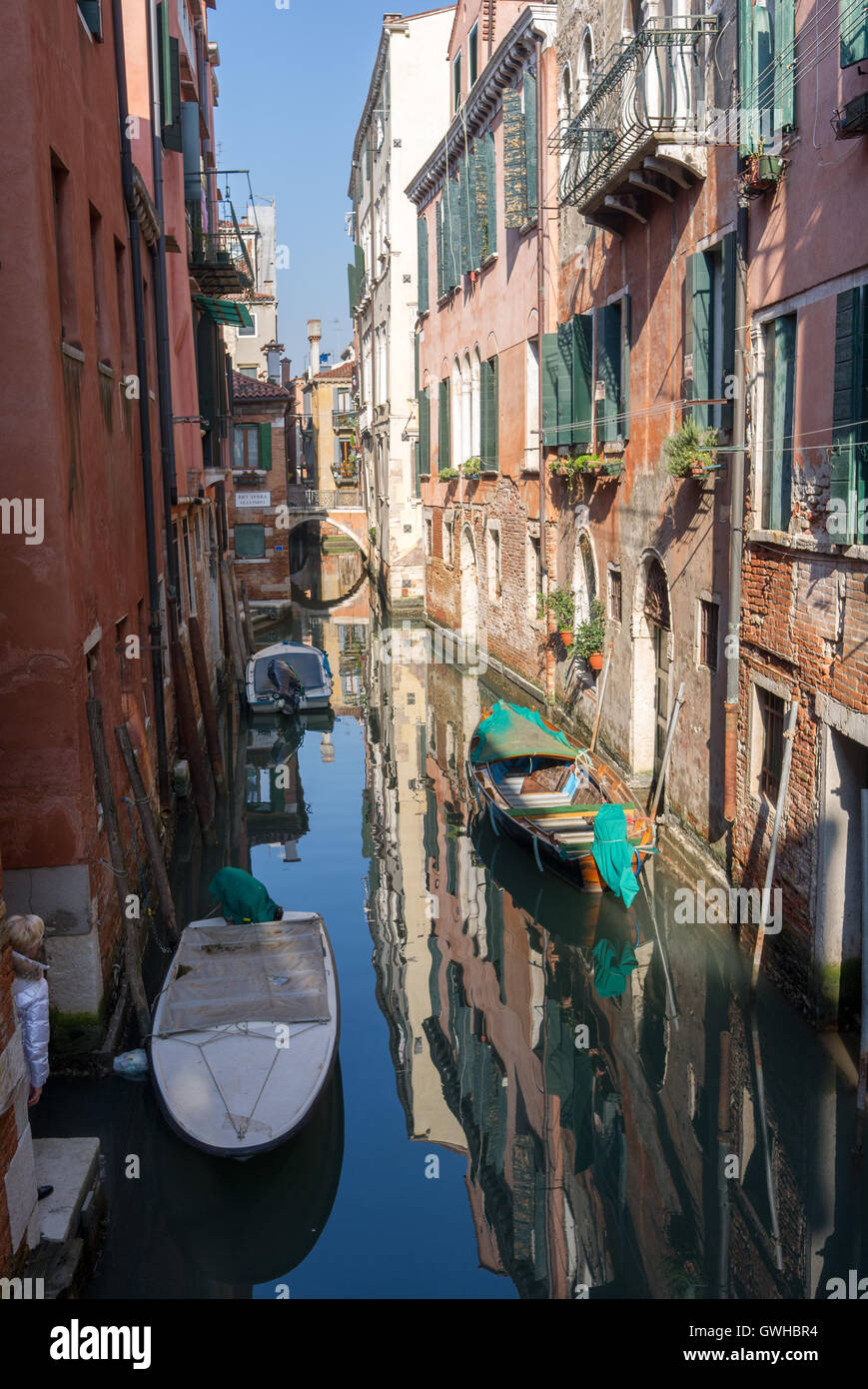 Boats on backwater canal in Venice Italy Stock Photo - Alamy