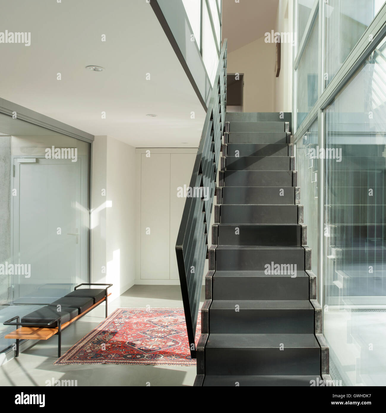 Interior of a modern house, hall with iron staircase Stock Photo - Alamy