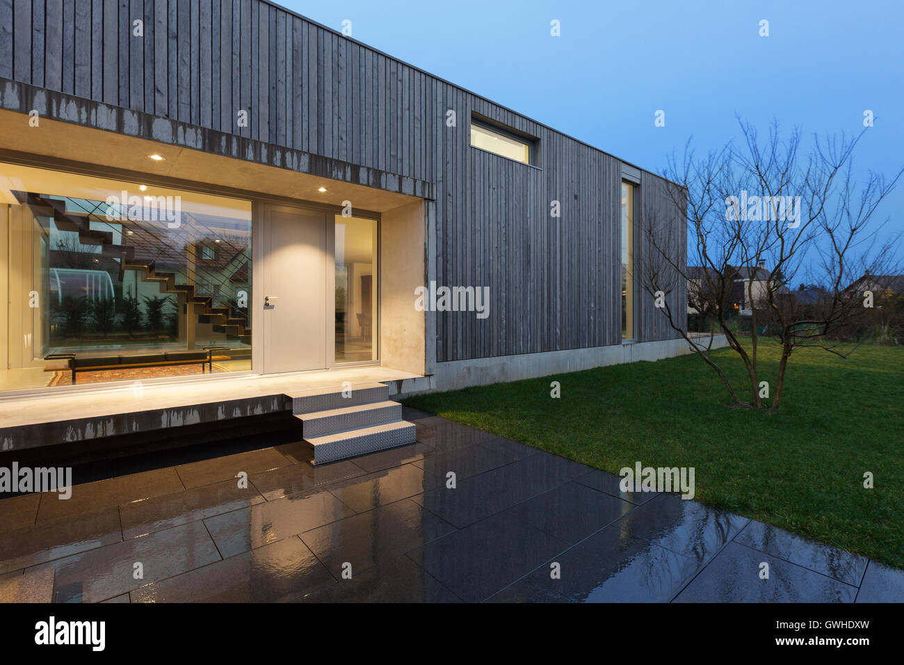 Entrance of a modern house, night scene Stock Photo - Alamy