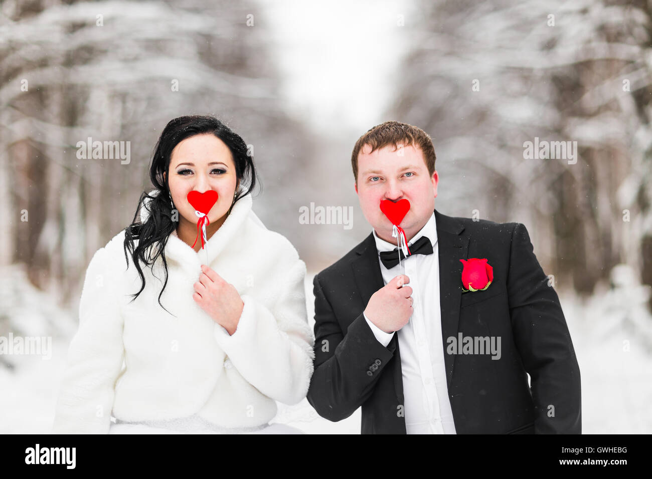 April Fools' Day. Wedding couple posing with mask Stock Photo - Alamy