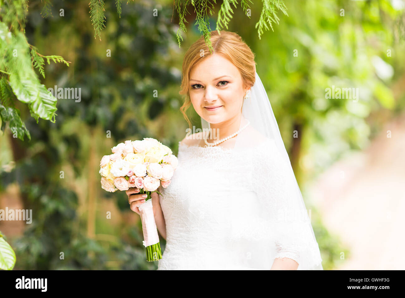 Bride Holding Wedding Bouquet Stock Photo - Alamy