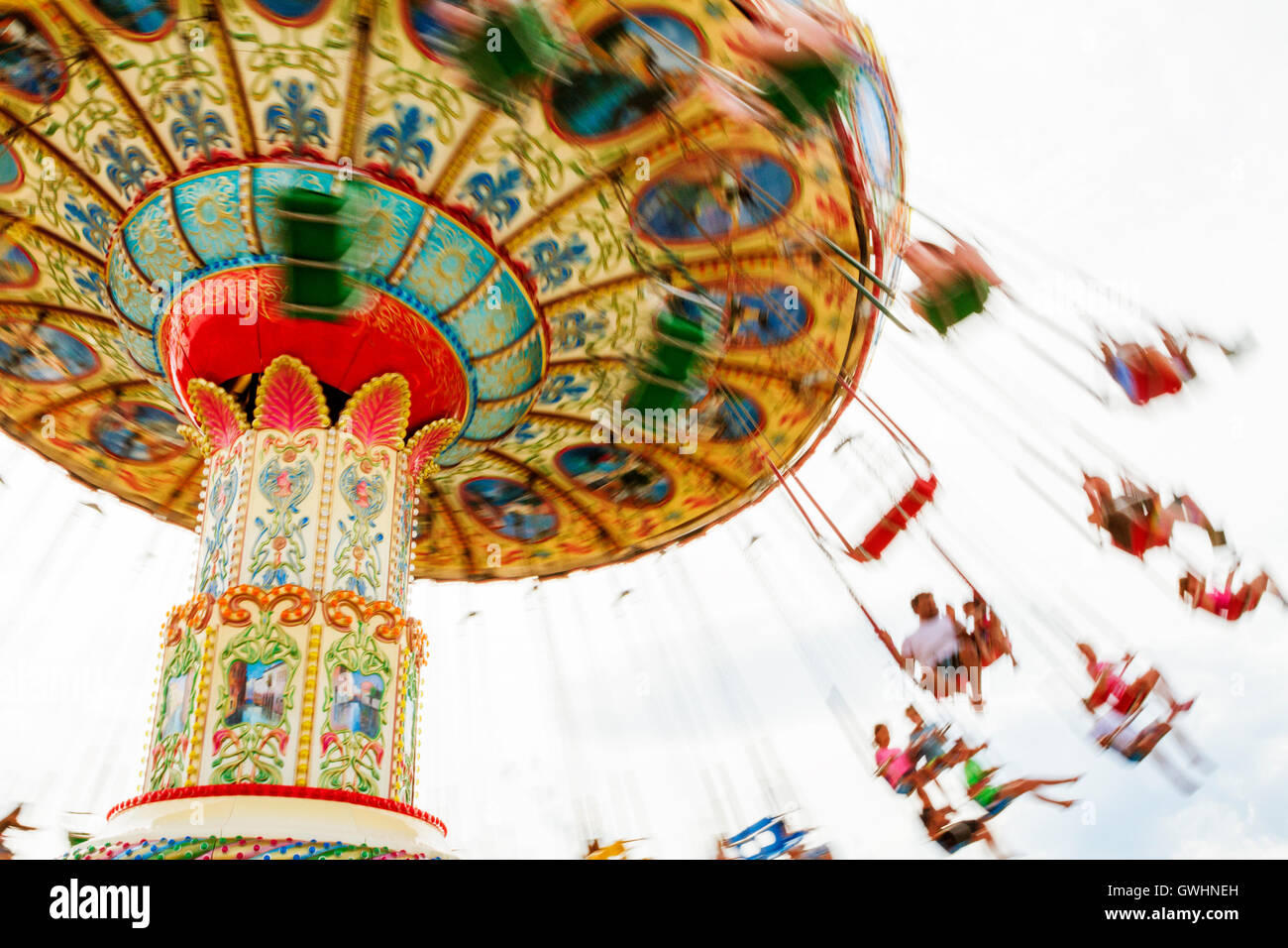 Children riding a colorful merry-go-round at the county fair Stock ...