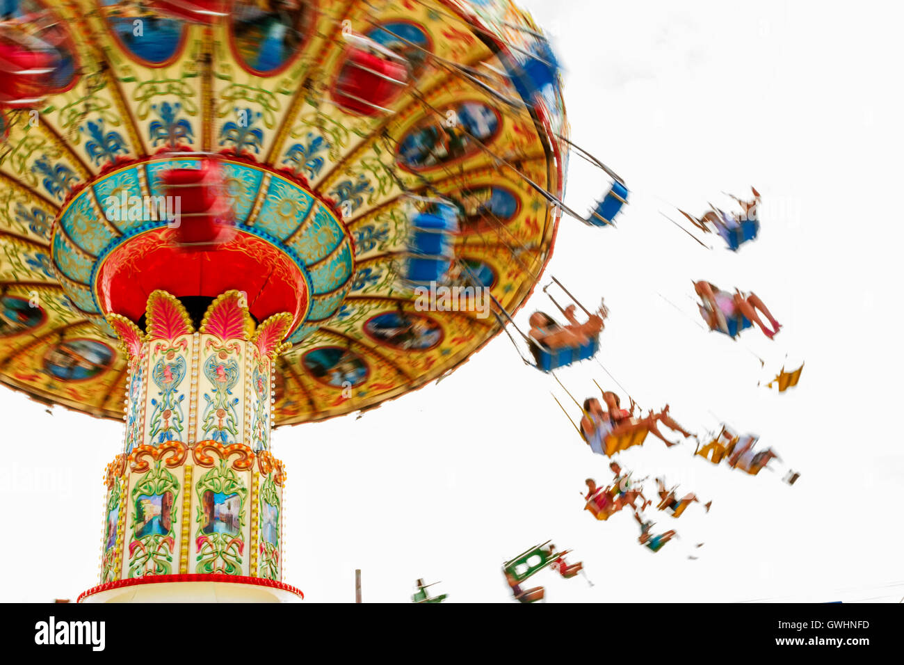 Children riding a colorful merry-go-round at the county fair Stock ...