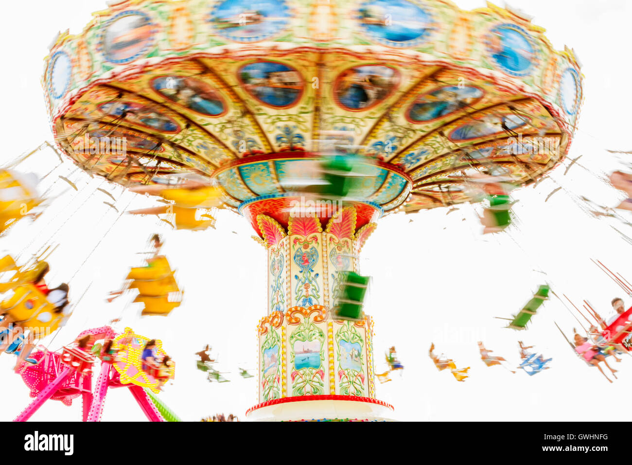 Children riding a colorful merry-go-round at the county fair Stock ...