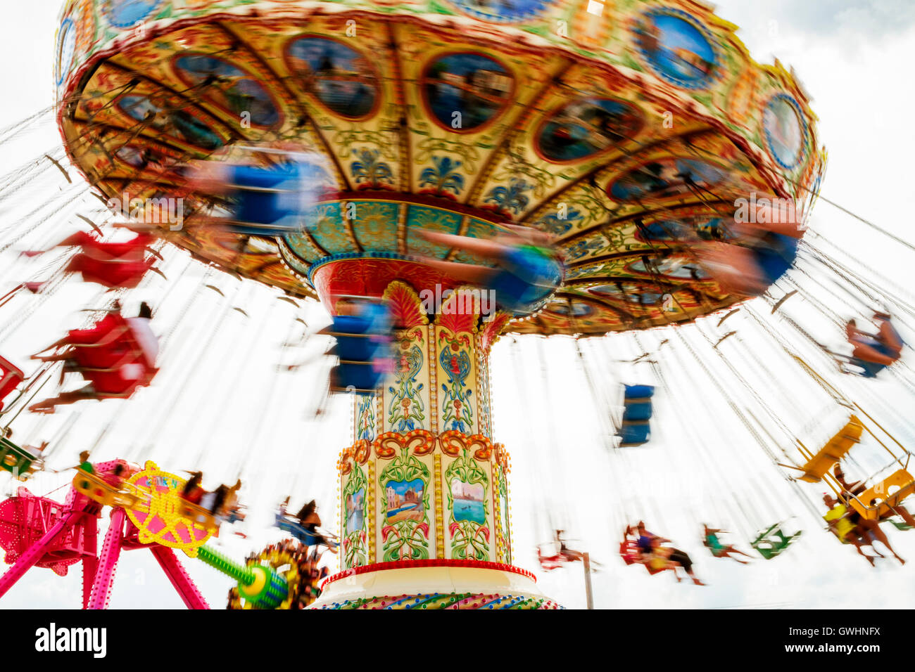 Children riding a colorful merry-go-round at the county fair Stock ...
