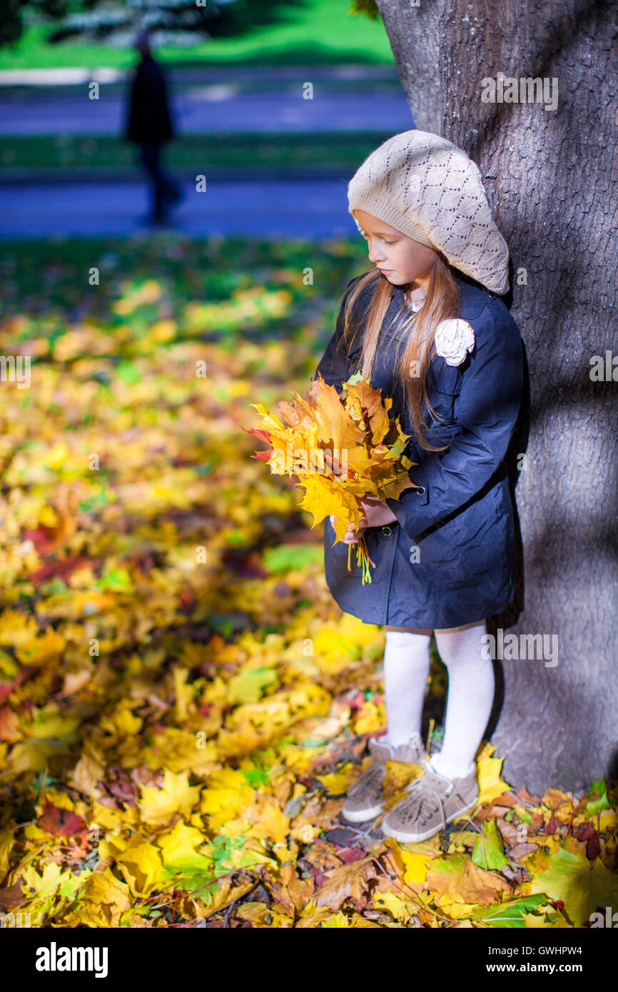 Little beautiful girl on the autumn meadow in a sunny fall day Stock ...