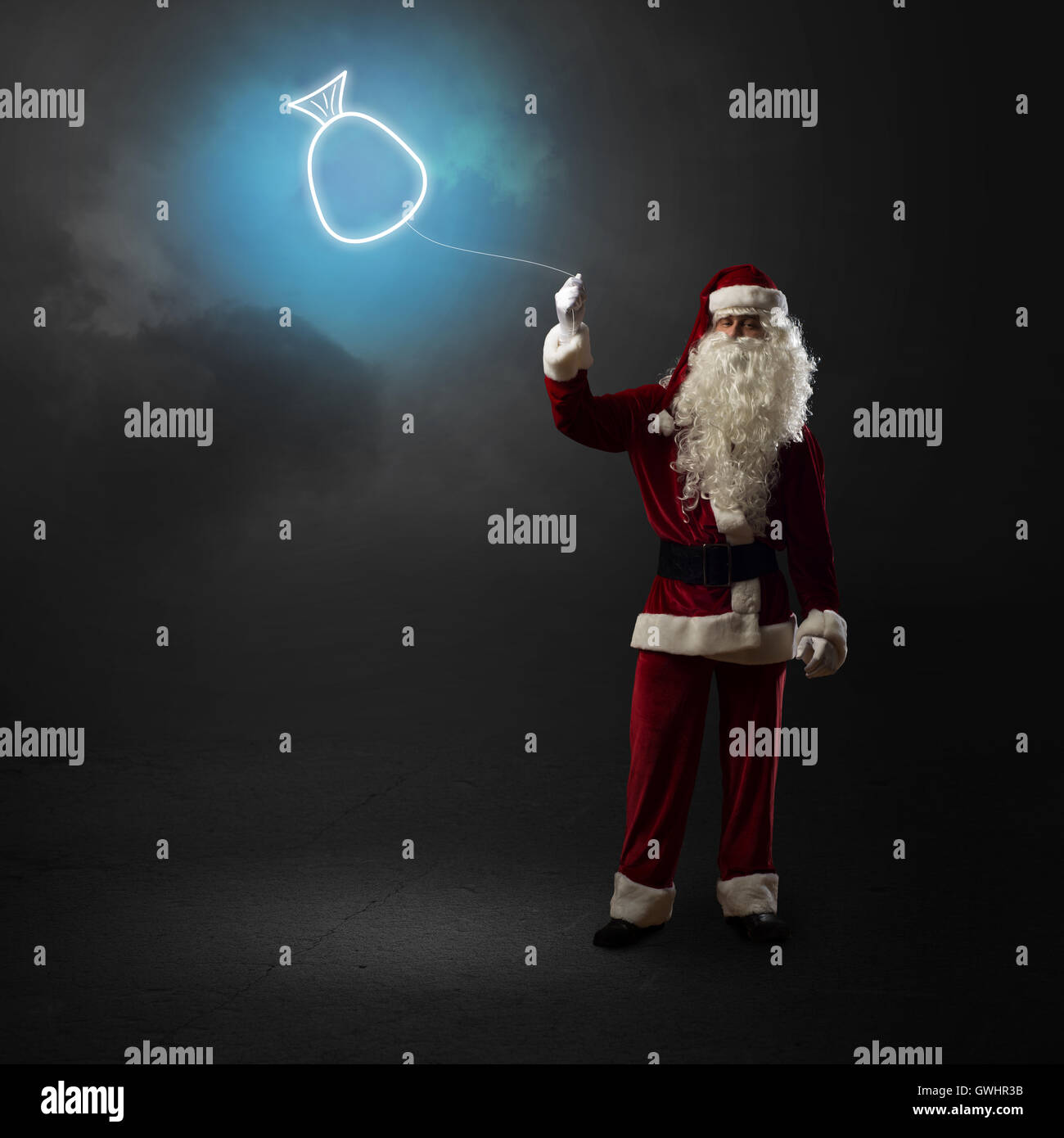 Santa Claus is holding a shining bag Stock Photo - Alamy