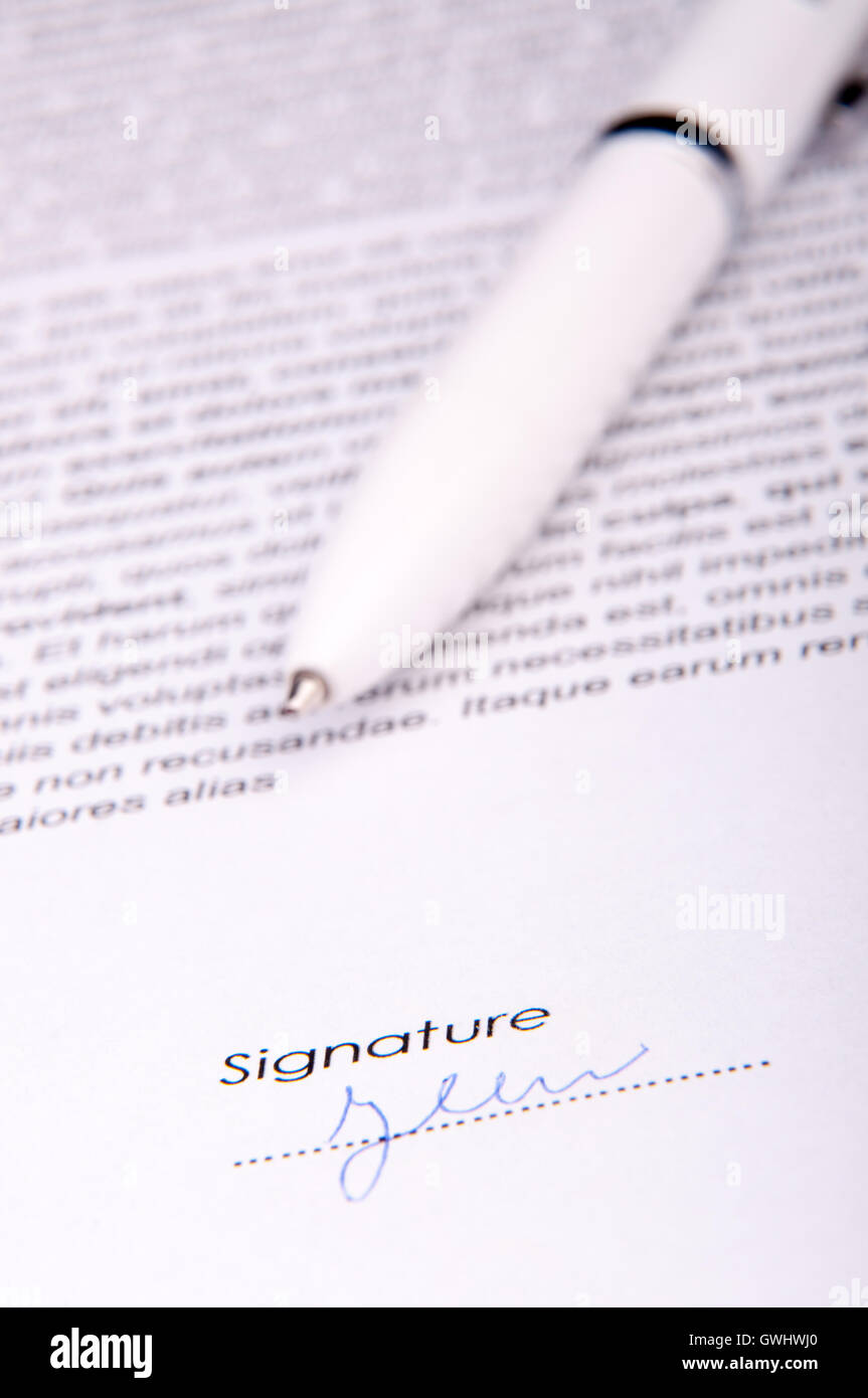 Signature over agreement Stock Photo - Alamy