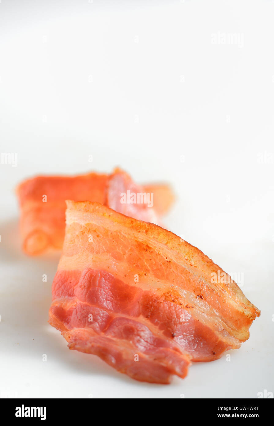 cooked slice of bacon isolated on white Stock Photo - Alamy