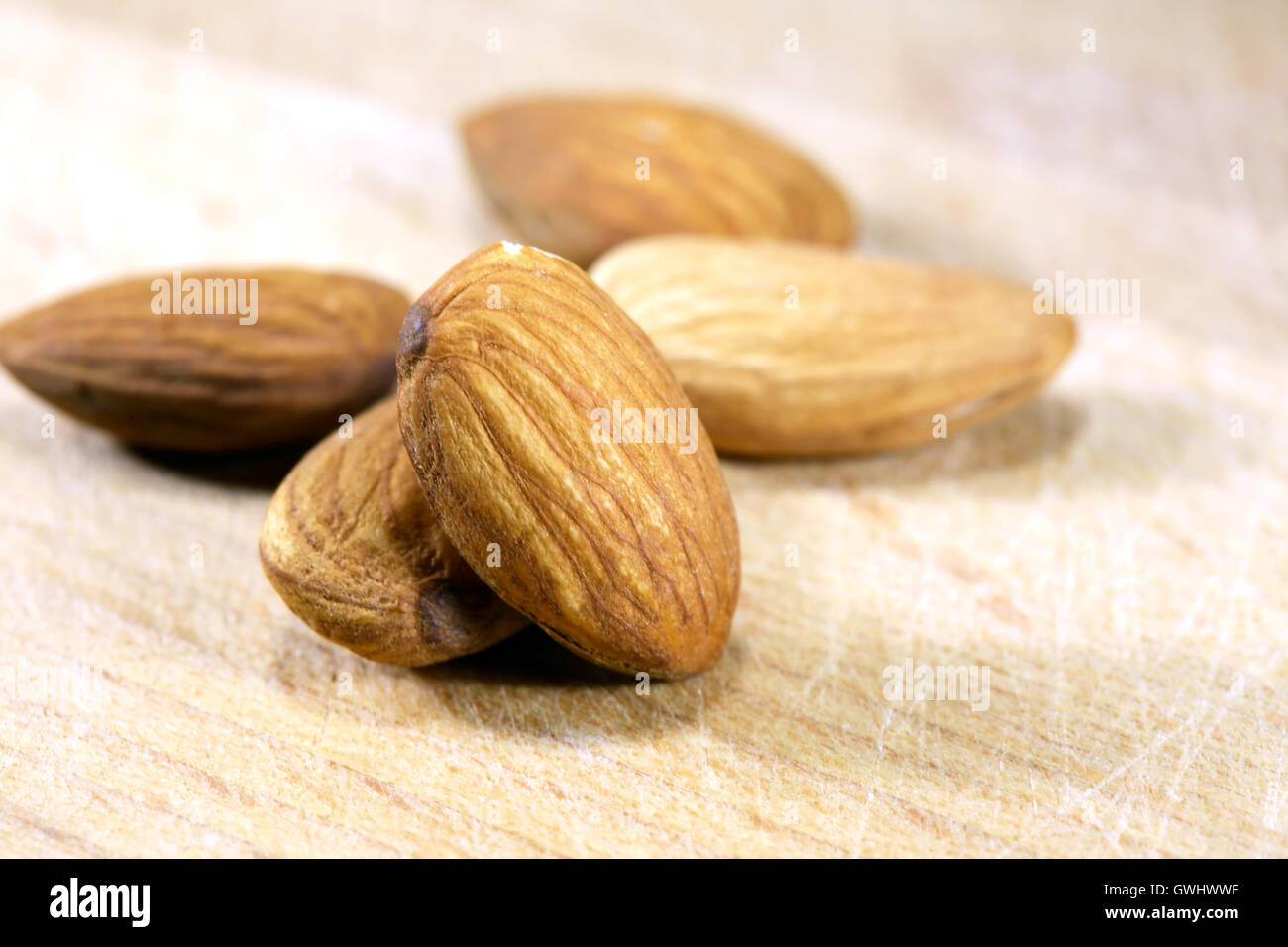 Almonds On Wood Stock Photo - Alamy