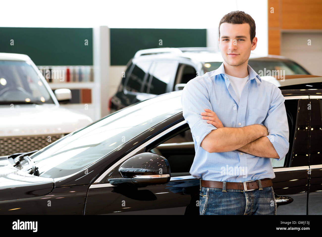 man standing near a car Stock Photo - Alamy