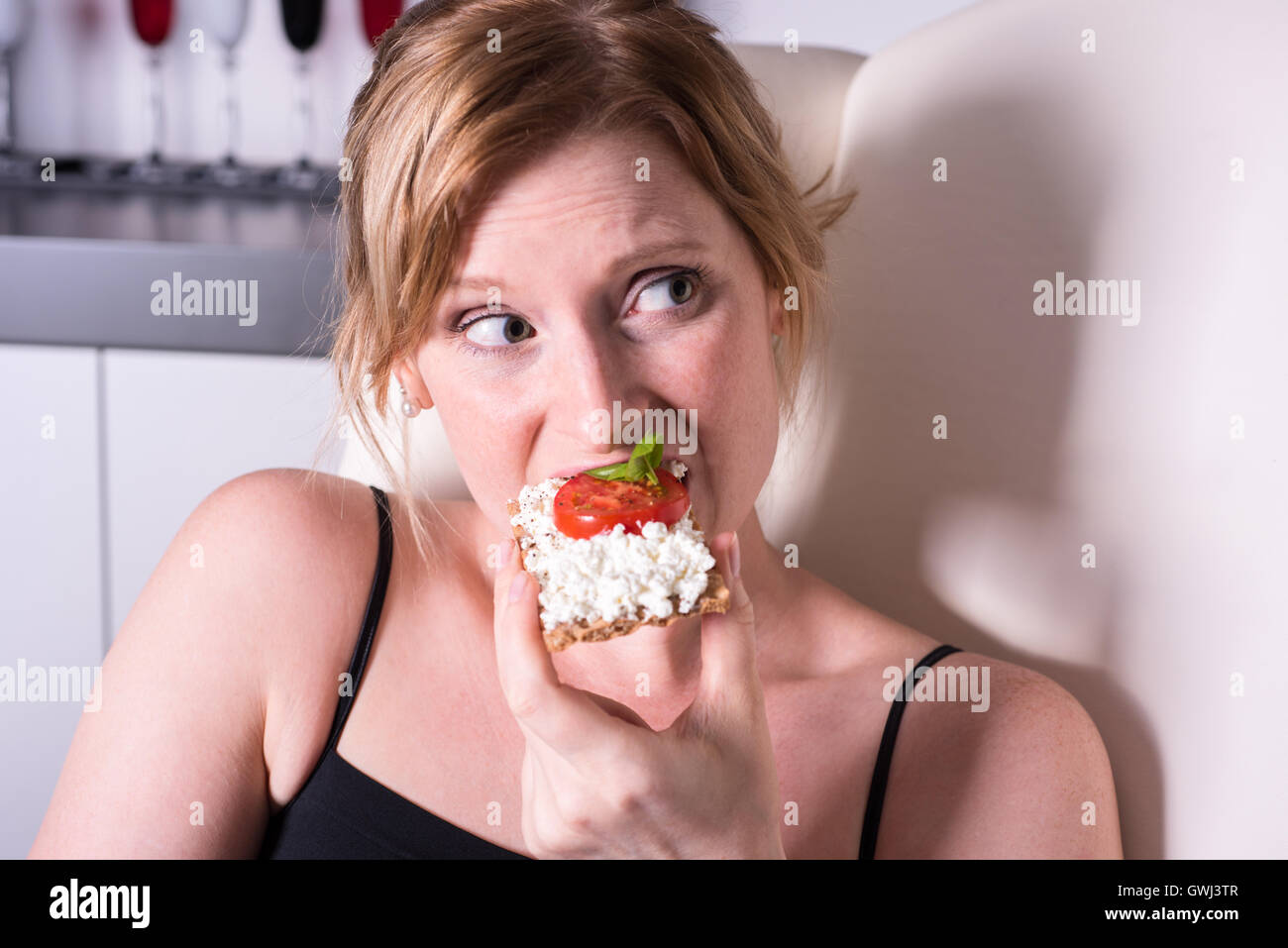 beautiful blonde woman is her bread with cheese and tomato Stock Photo ...