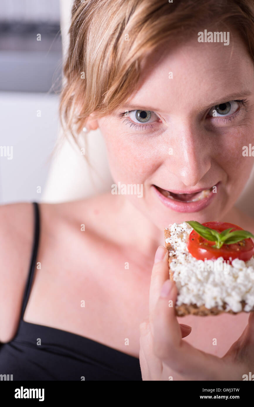 beautiful blonde woman is her bread with cheese and tomato Stock Photo ...