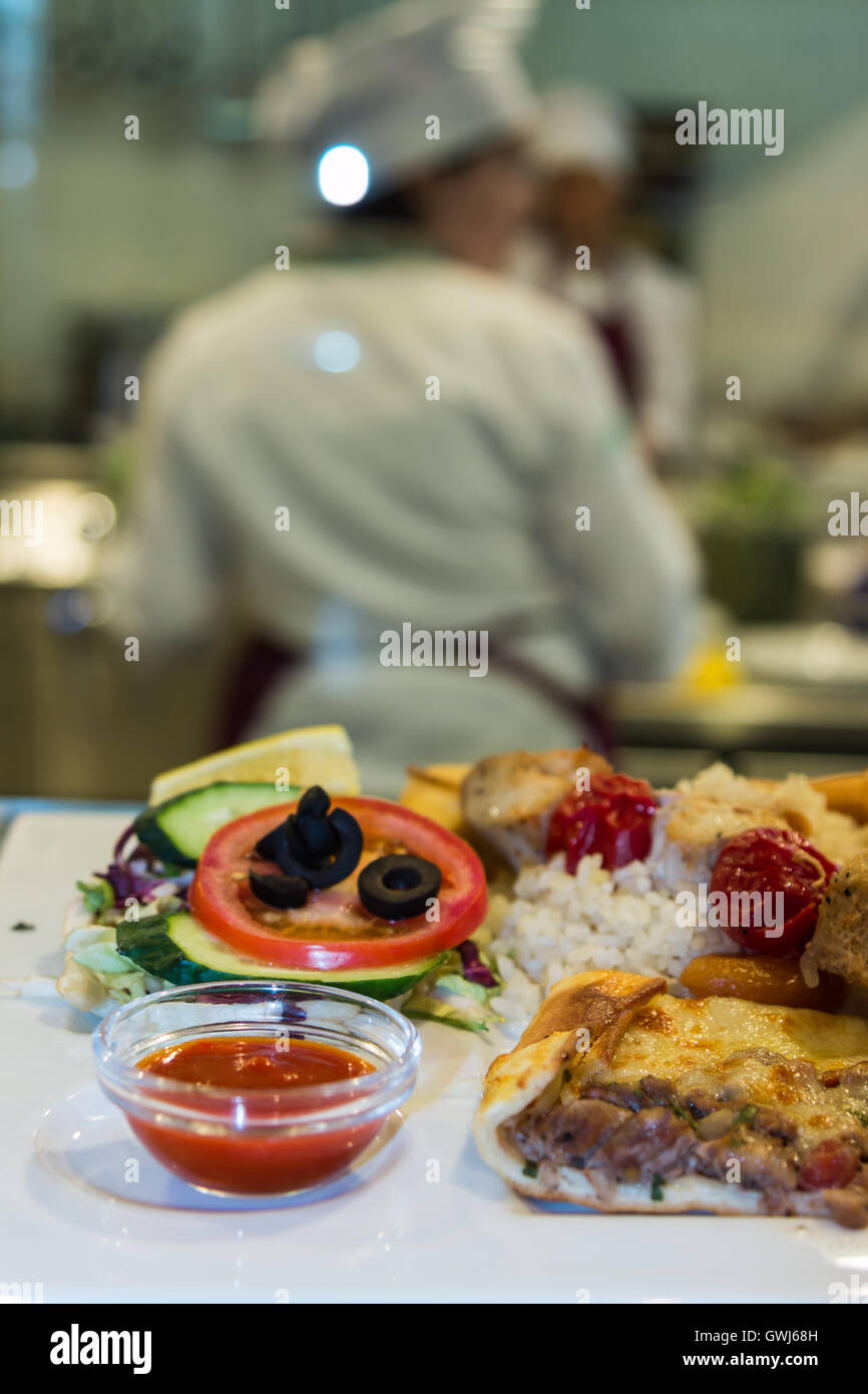Fresh Ready Dishes and Female Chef in Background Stock Photo - Alamy