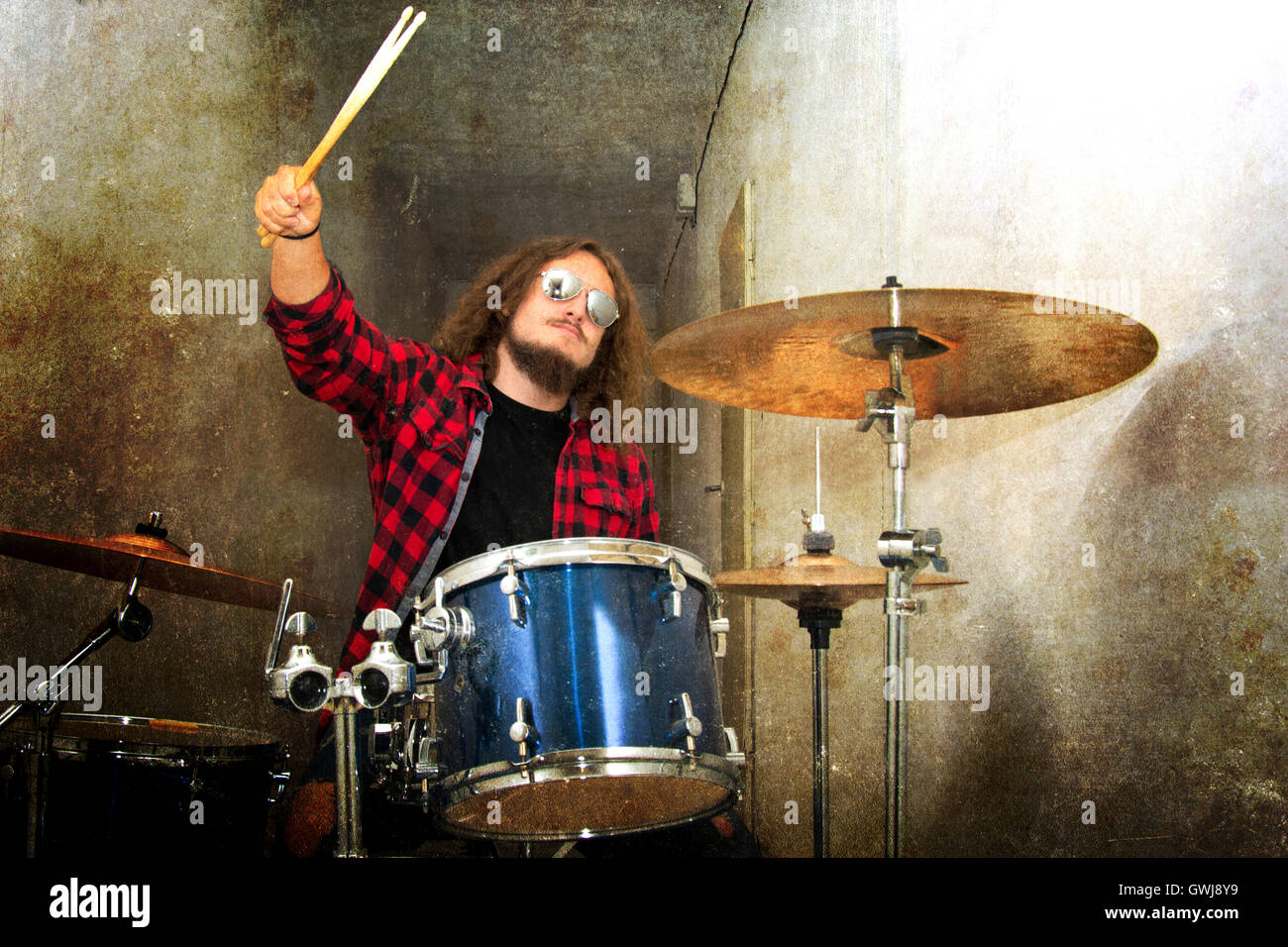Drums conceptual image. Rock drummer holding drumsticks and playing on ...