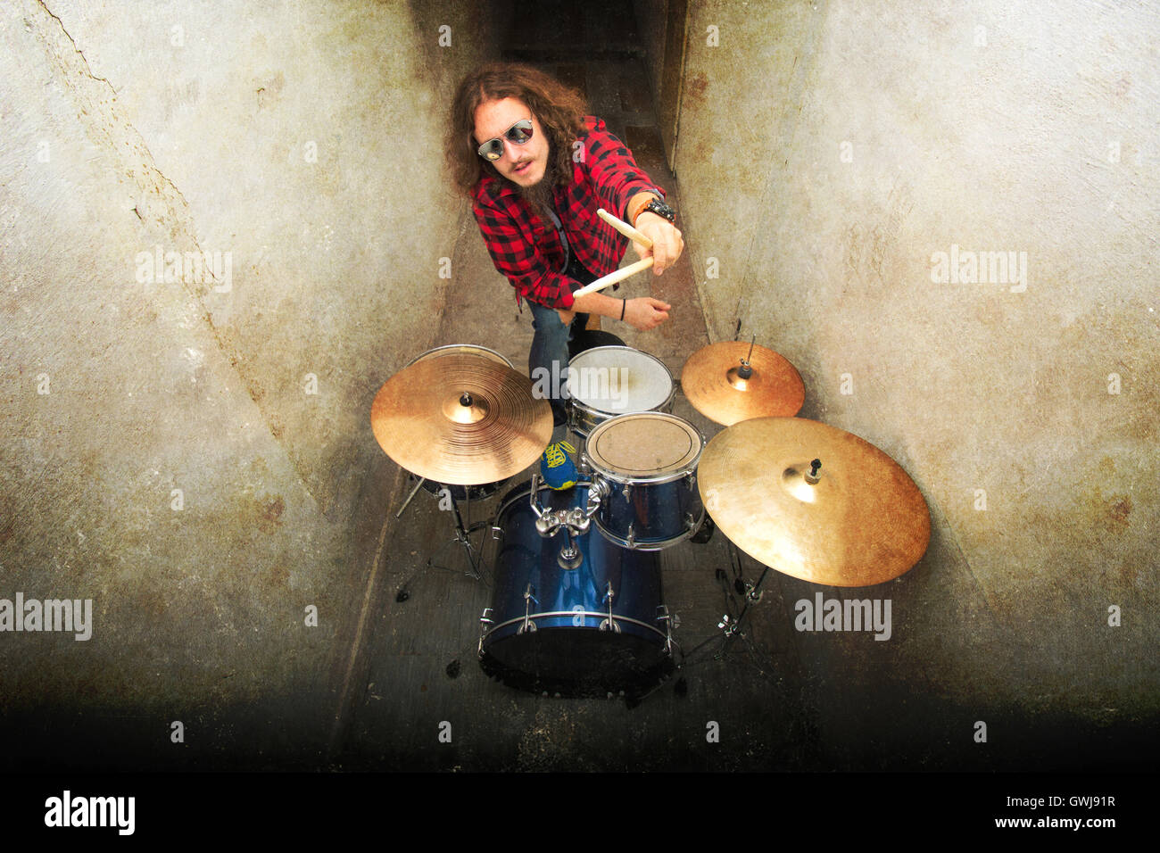 Drums conceptual image. Rock drummer holding drumsticks and playing on ...