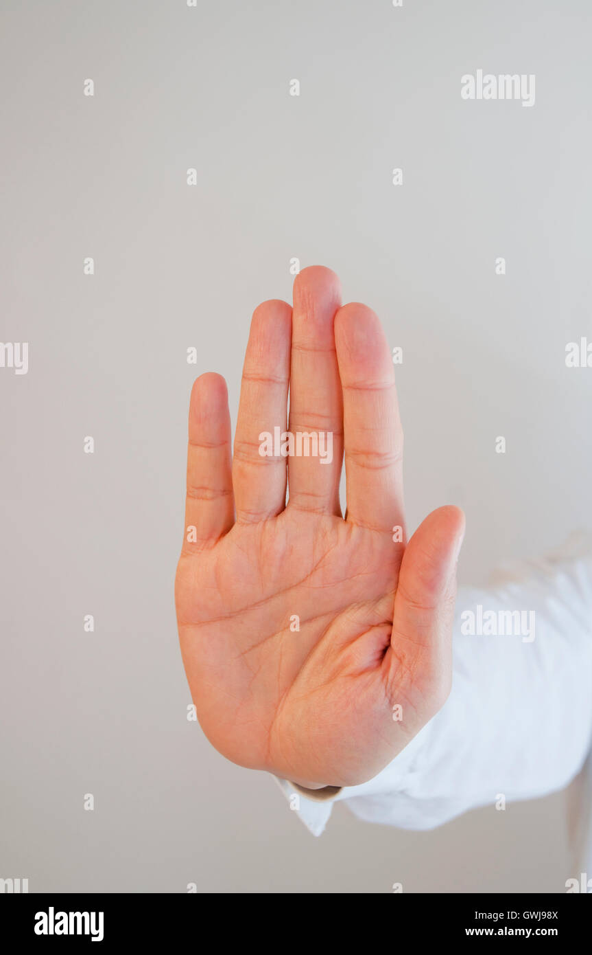 Man's hand indicating stop Stock Photo - Alamy