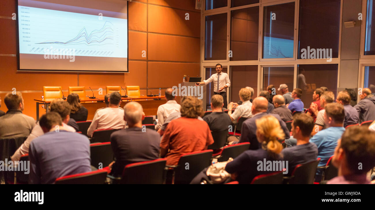 Business speaker giving a talk in conference hall Stock Photo - Alamy