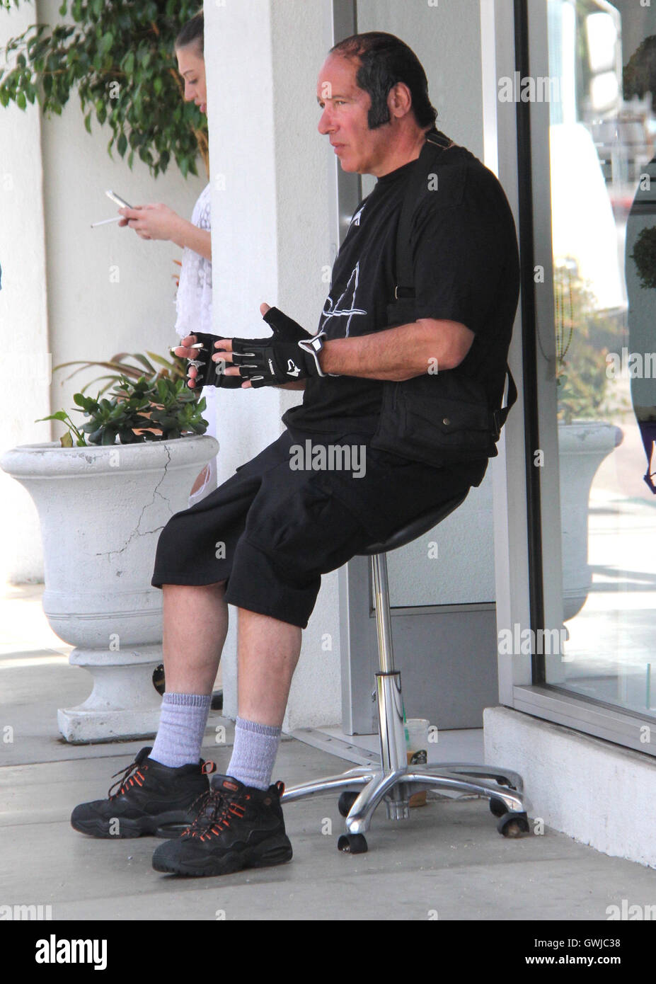 Andrew Dice Clay sits down to have a cigarette whilst out in Beverly ...