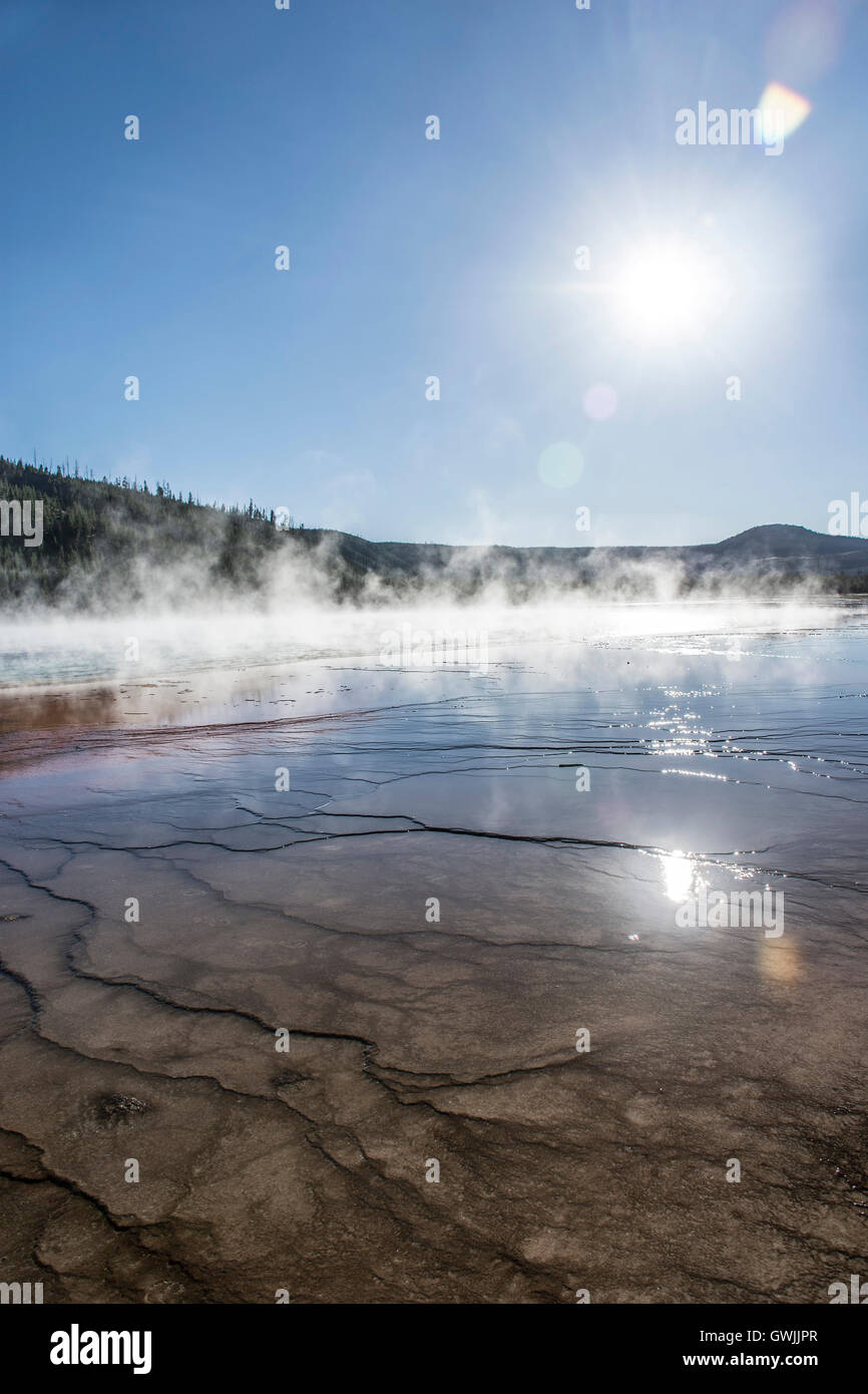 Ripples and Steam with reflections and sun flare in Midway Geyser Basin ...