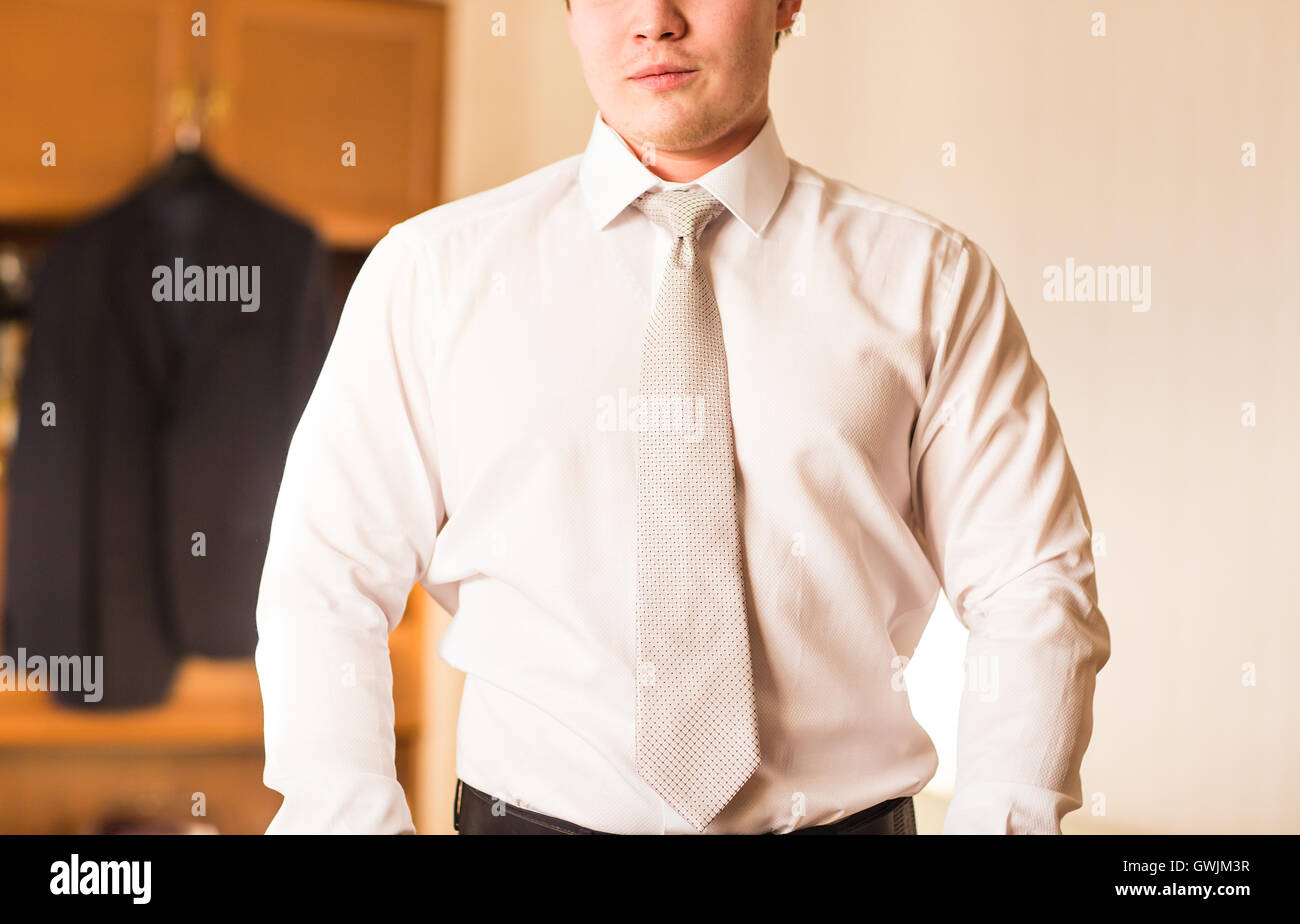 People, business, fashion and clothing concept - man in shirt dressing ...