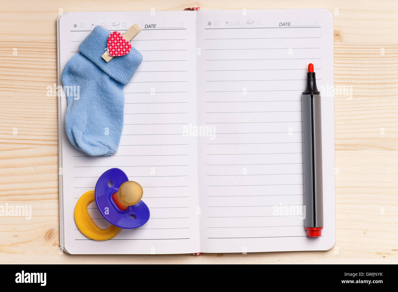 Notepad and baby shoes - top view Stock Photo - Alamy