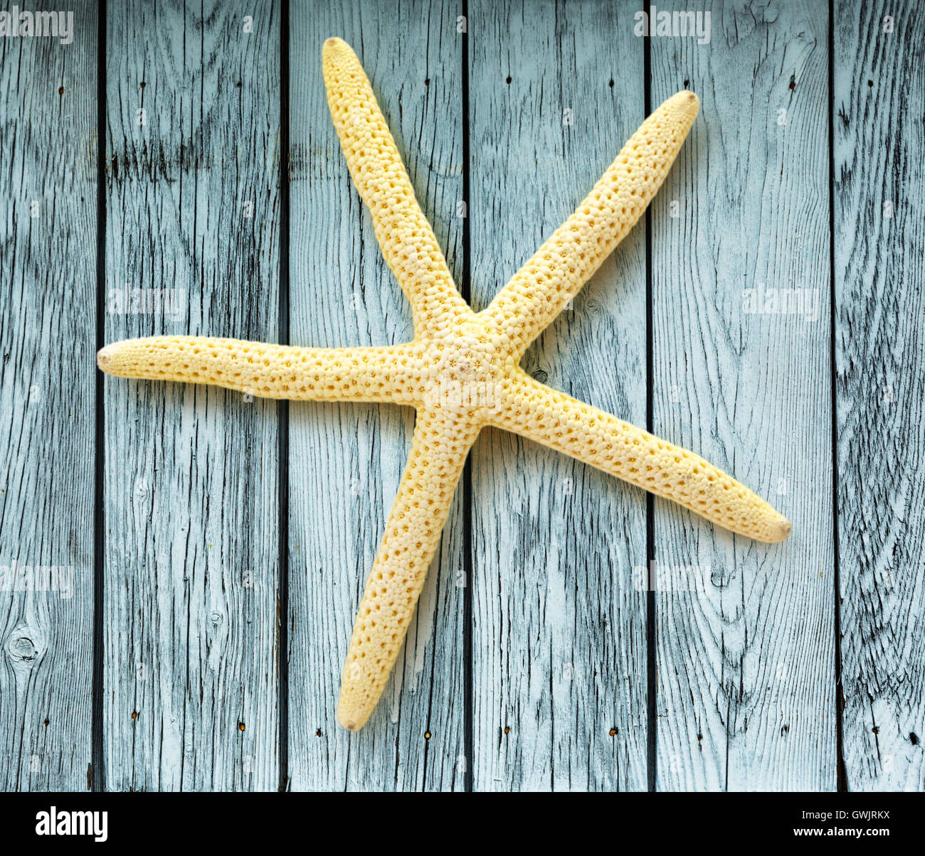 Decorative white sea star on wooden background Stock Photo - Alamy