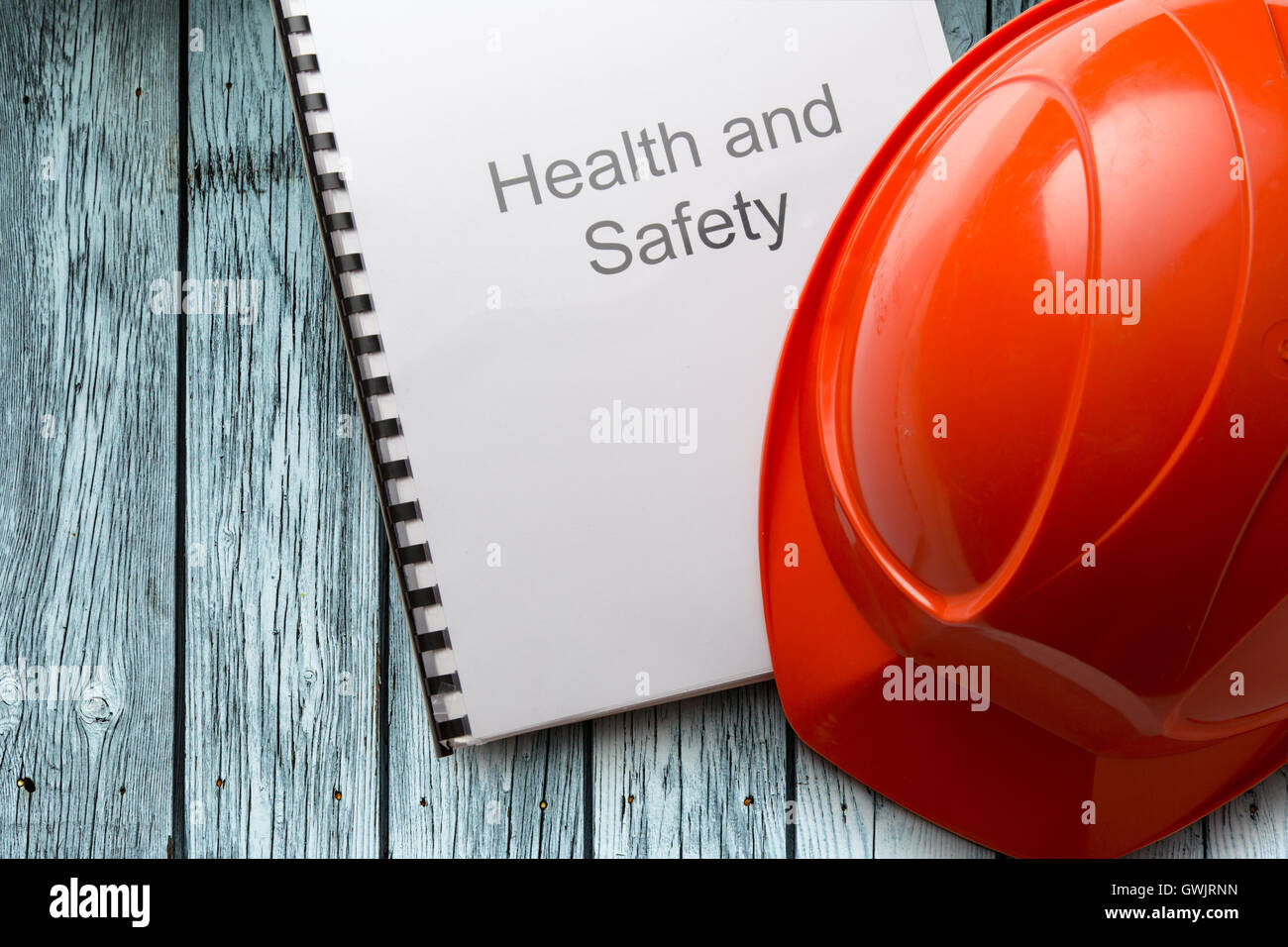 Health and safety register with helmet in closeup Stock Photo - Alamy