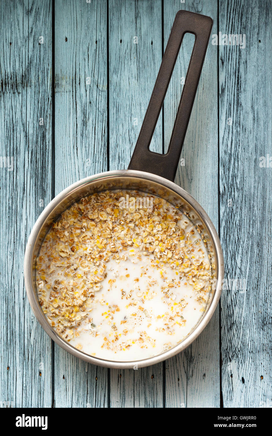 Cooking healthy porridge in metal pot closeup Stock Photo - Alamy