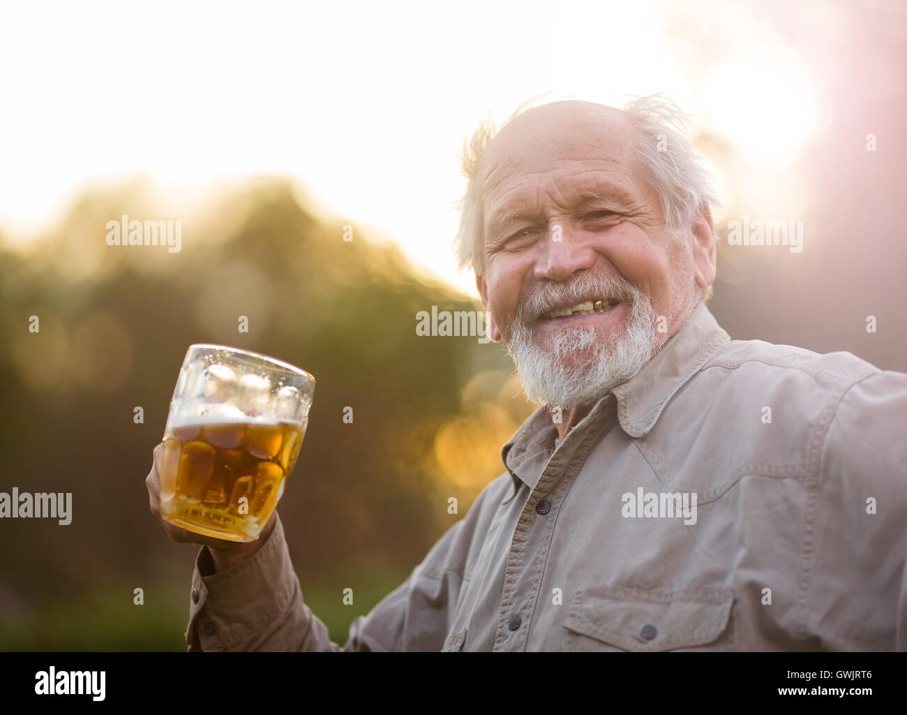 The senior drinks beer from the mug Stock Photo - Alamy